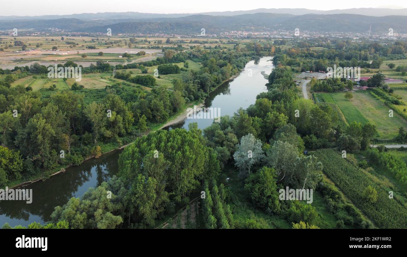 An aerial view of a deep river surrounded by dense forests Stock Photo ...
