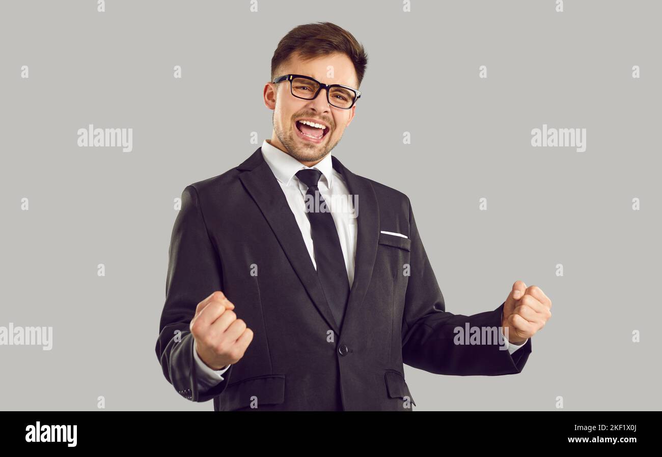 Happy excited businessman in suit and glasses celebrating success and ...