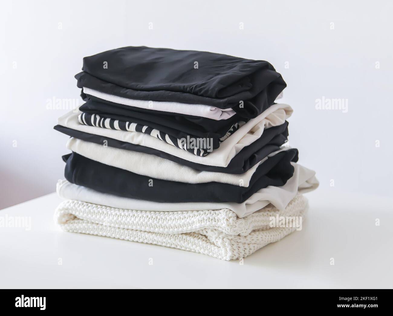 Stack of folded colorful clothes. Compact storage organizing in home ...