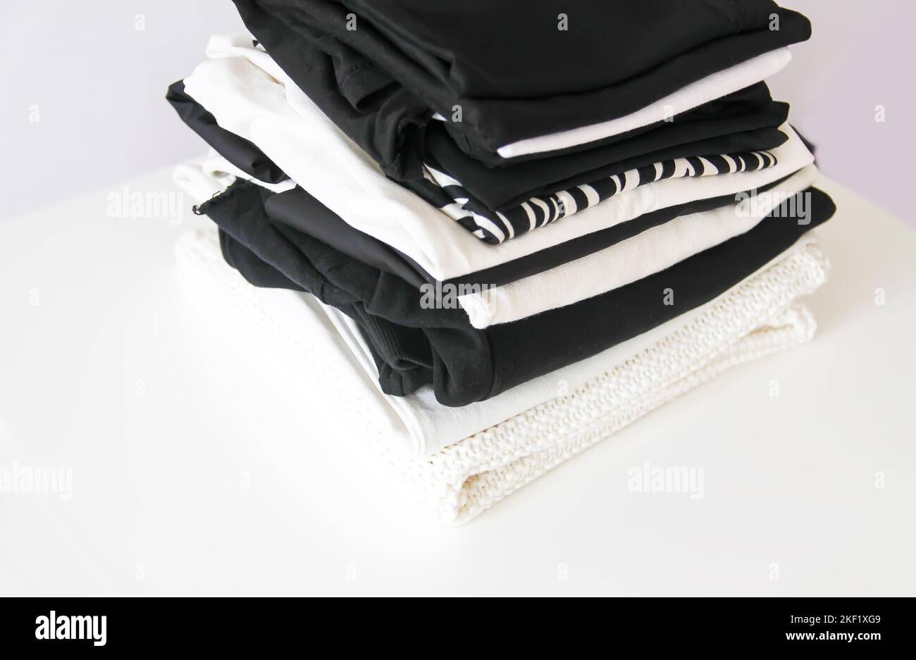 Stack of folded colorful clothes. Compact storage organizing in home ...