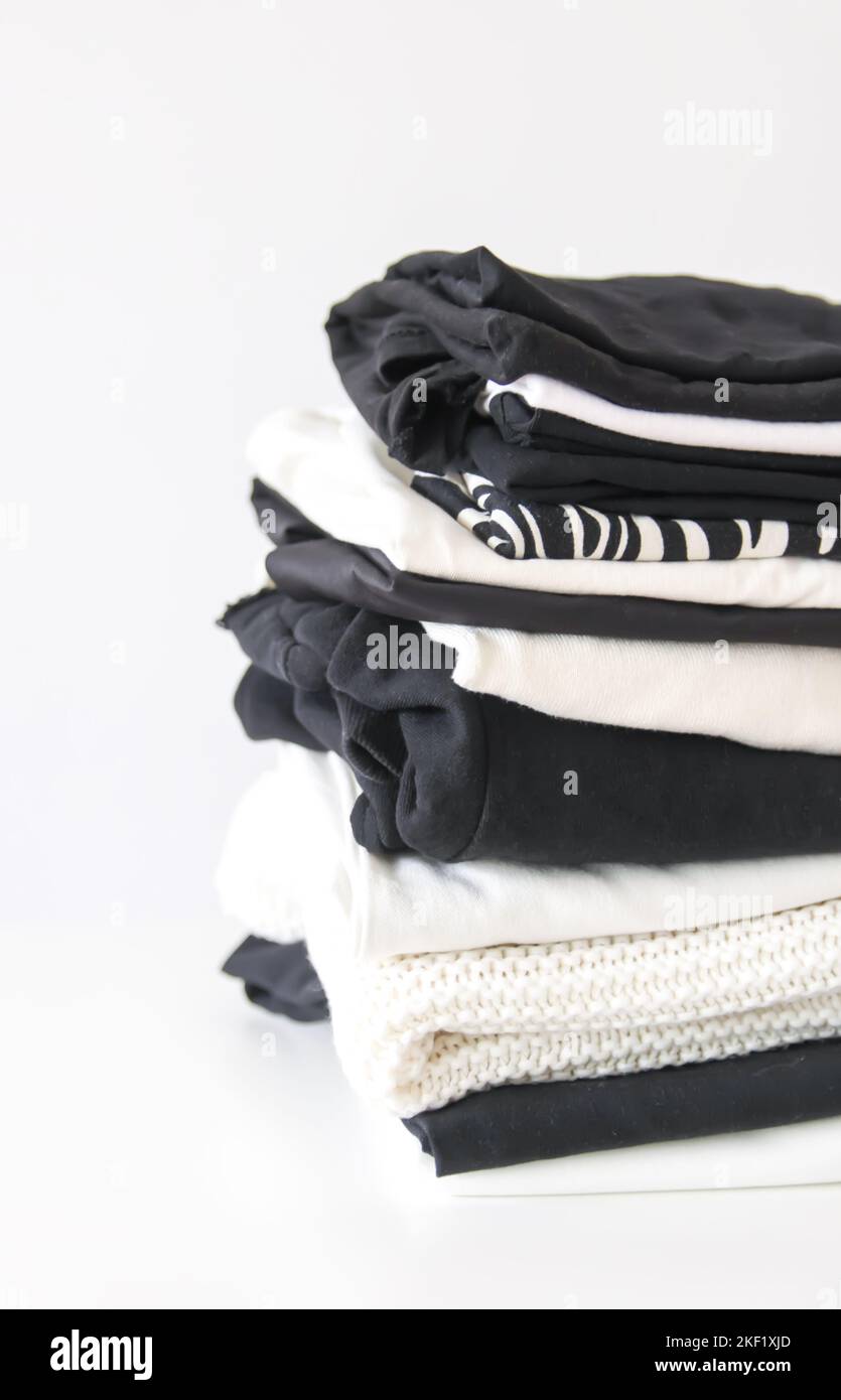 Stack of folded colorful clothes. Compact storage organizing in home ...