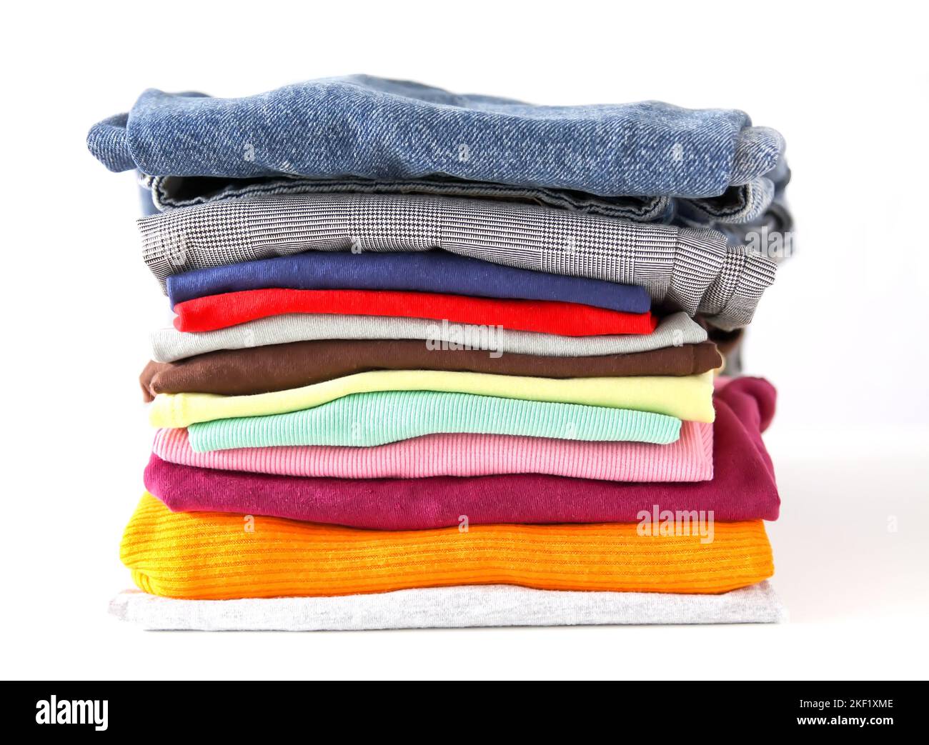 Stack of folded colorful clothes. Compact storage organizing in home ...