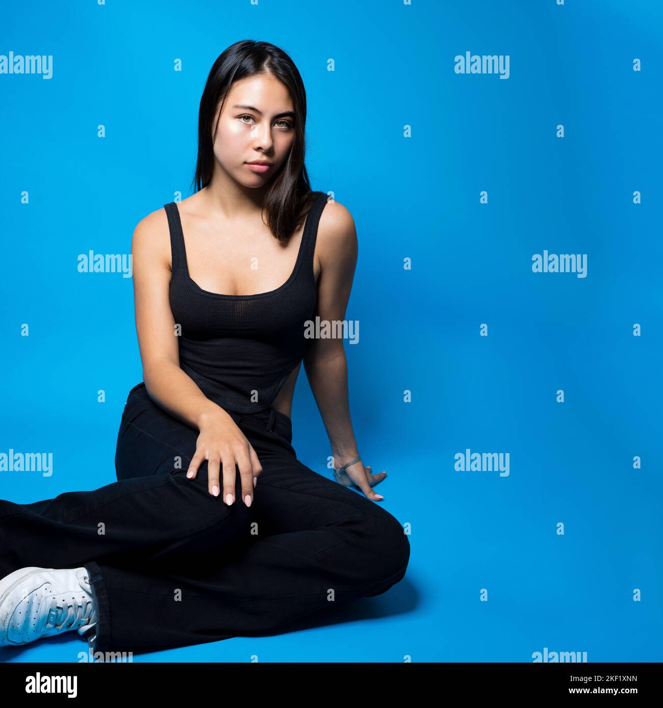 Multiracial Teen Z-Sitting Floor Copy Space on Blue Background Stock ...