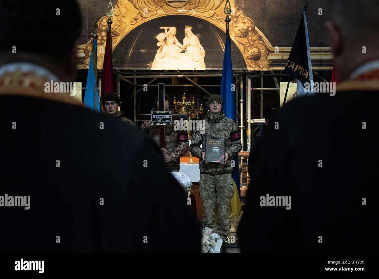 Soldiers seen carrying Tsengís photo and a cross marked with his name ...