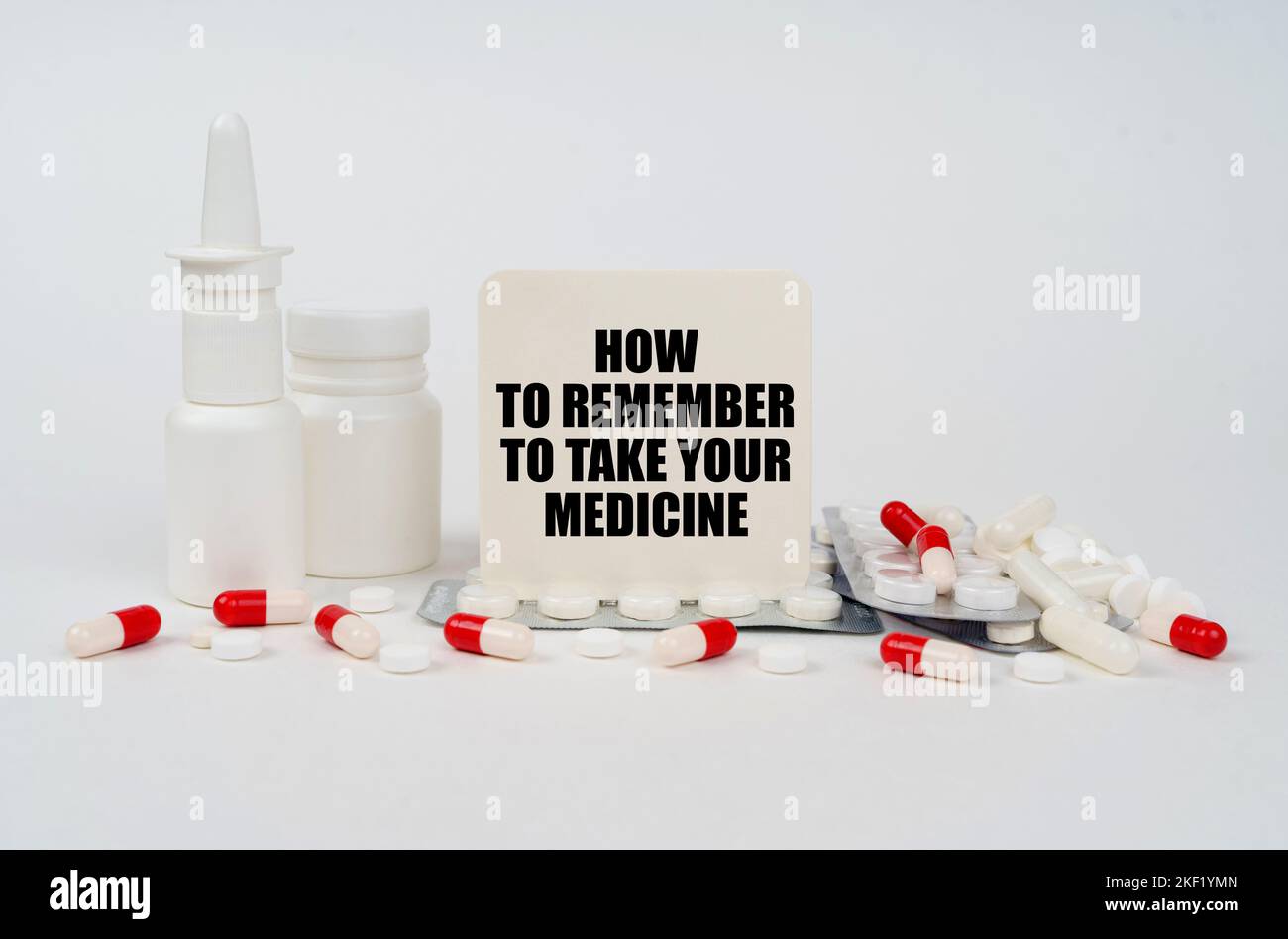 Medical concept. On a white surface, blisters, tablets, spray and a ...