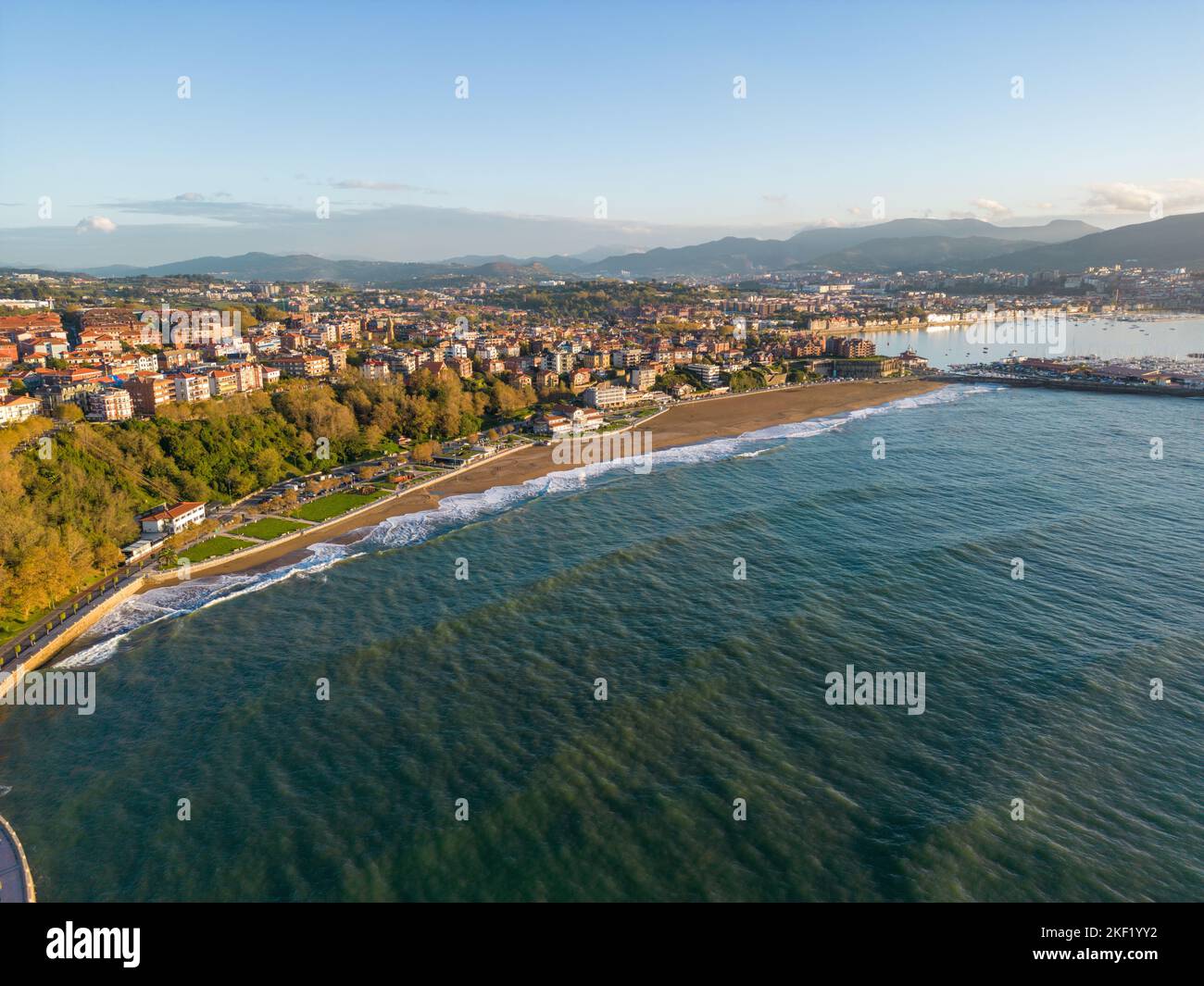 An aerial view of cityscape Basque surrounded by buildings and water ...