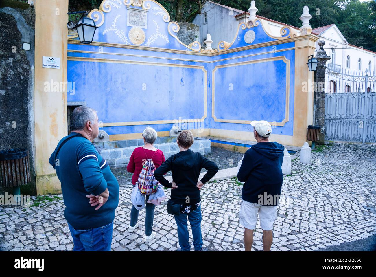 Tourists admire an ornate font Fonte da Sabuga on the mountain above ...