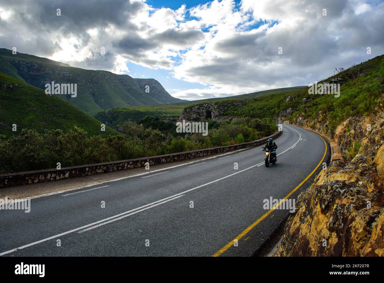 An aerial view of human riding motorcycle on road surrounded by ...
