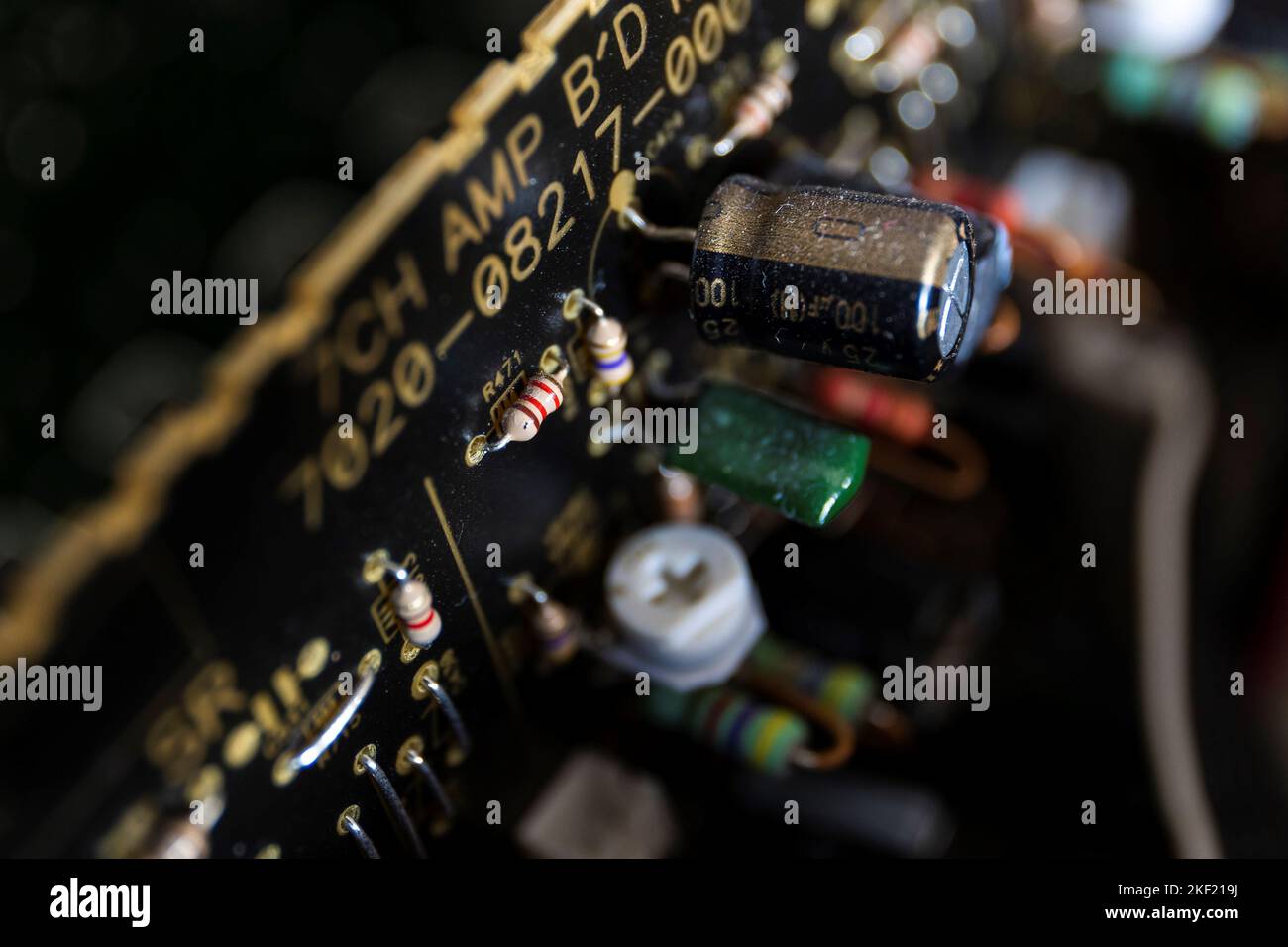 A portrait of a black electronic circuit board with the focus on a ...