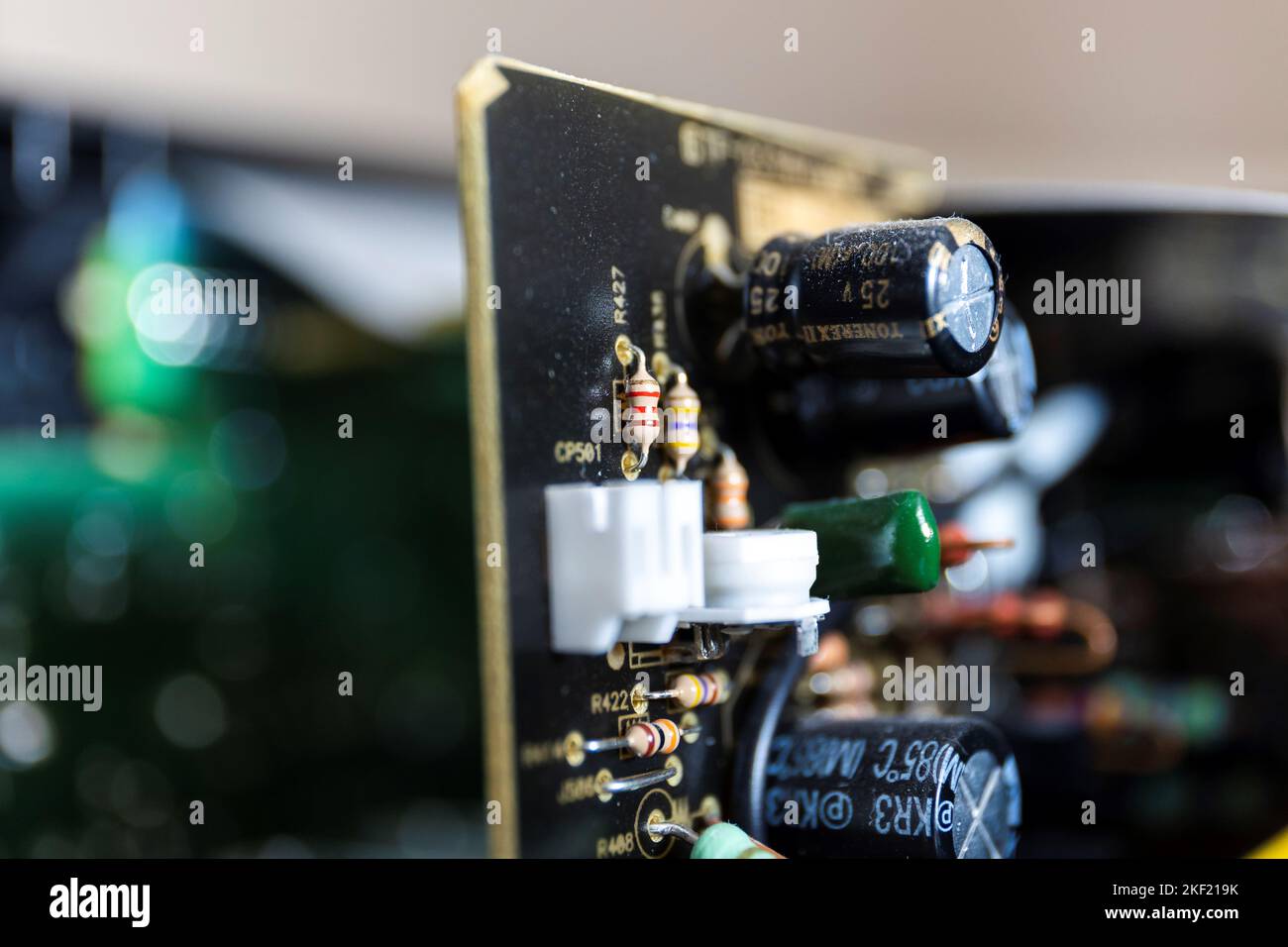 A Close Up Portrait Of Some Resistors And Capacitors On A Black Circuit Board In An Open