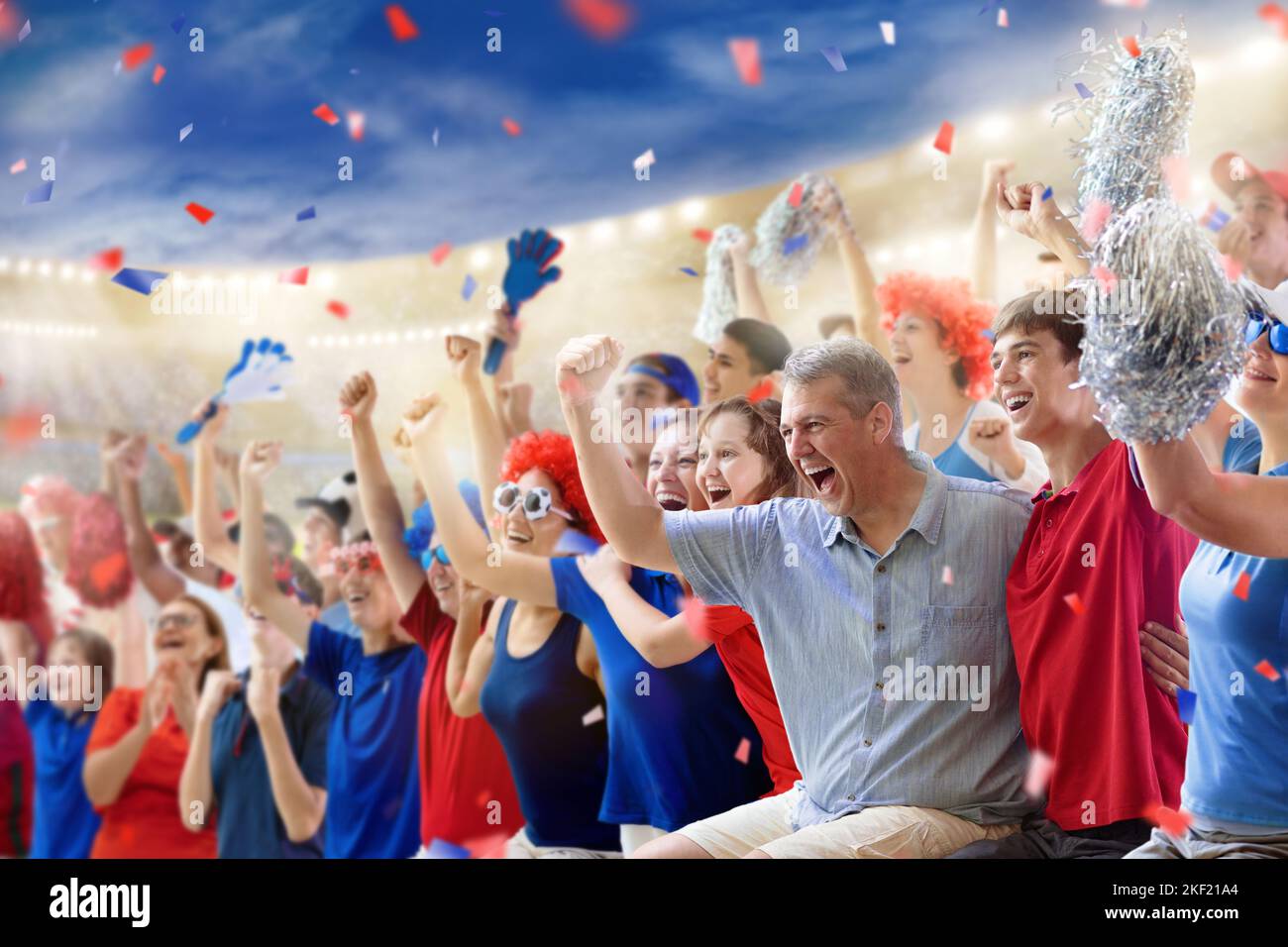 Football supporter on stadium in red and blue shirt. Happy fans on ...