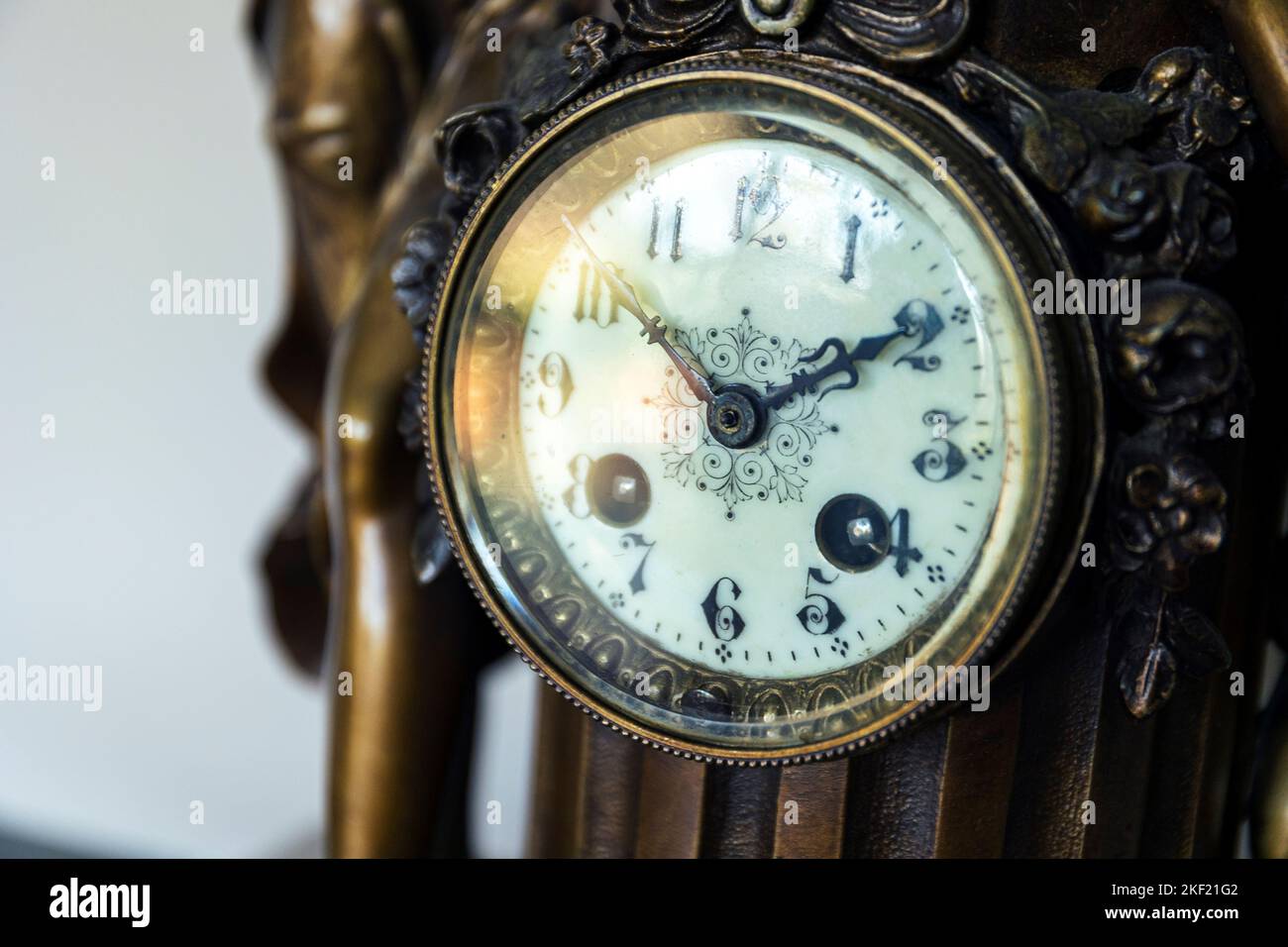 A closeup portrait of the vintage clock face of an old retro clock made ...