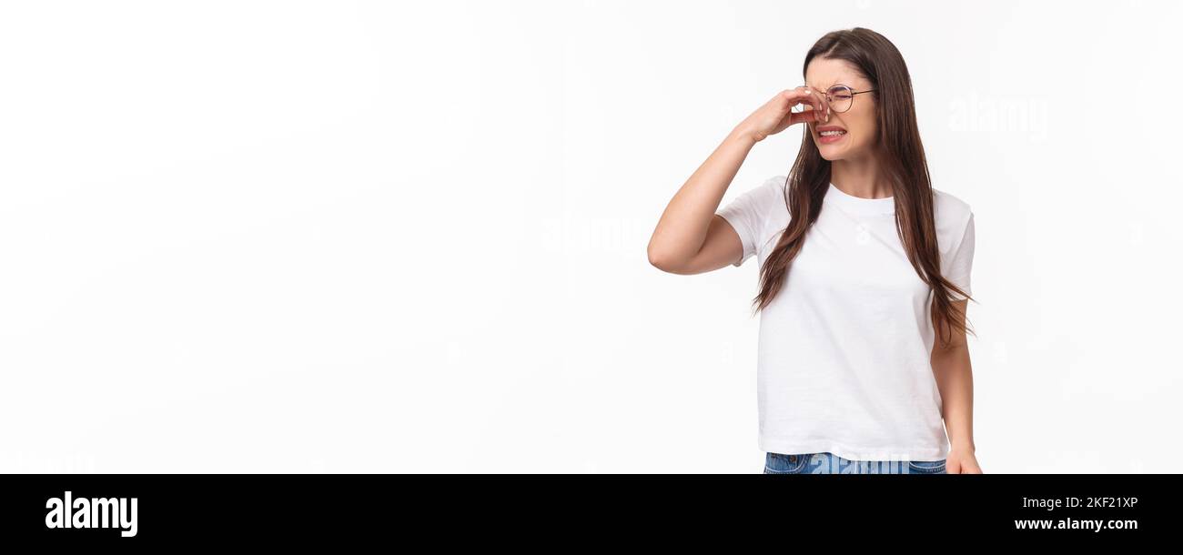 Smells disgusting. Portrait of disgusted and displeased young beautiful ...