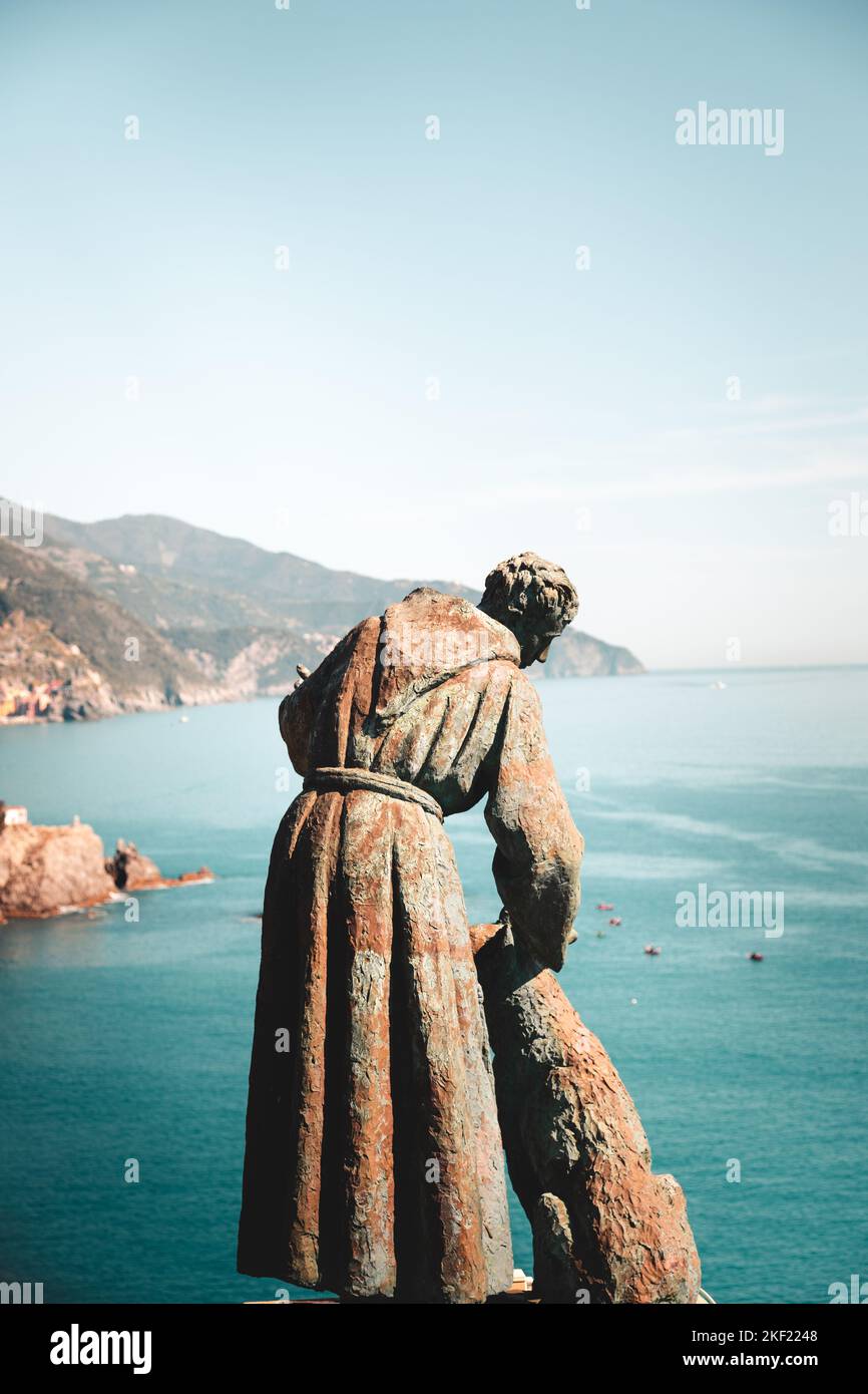 A vertical shot of the Statue of Saint Francis of Assisi with dog in ...