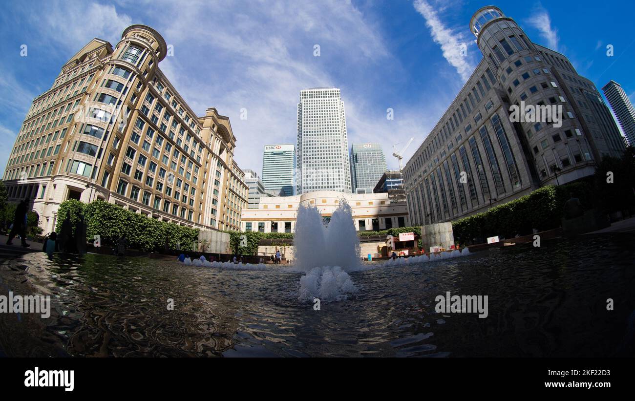 A close-up shot of a water fountain with the background of buildings ...