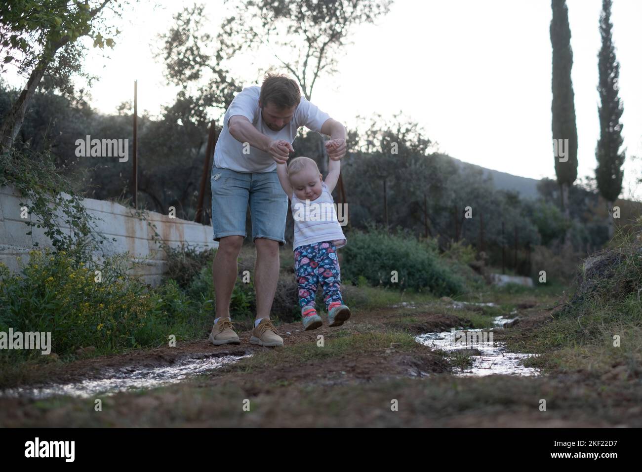 Happy family on a walk in summer. Child walking with father together ...