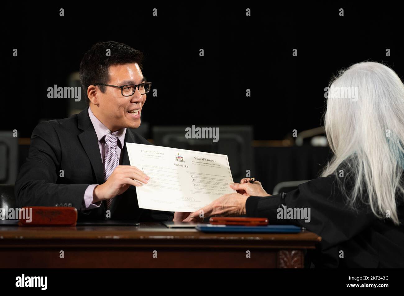 Ottawa City Councillor for Barrhaven East Ward Wilson Lo left, shares a ...