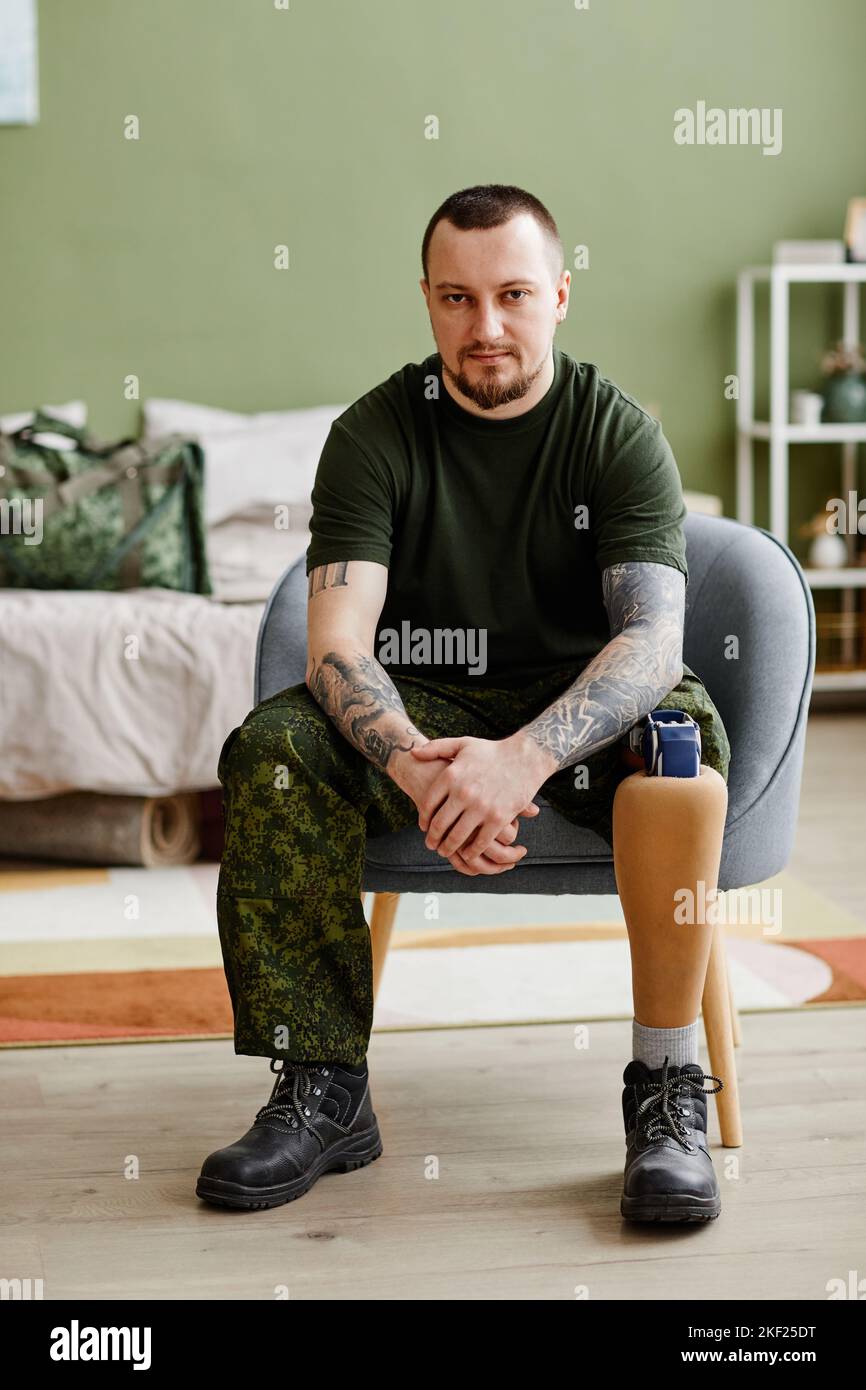 Full length portrait of military veteran with prosthetic leg wearing ...