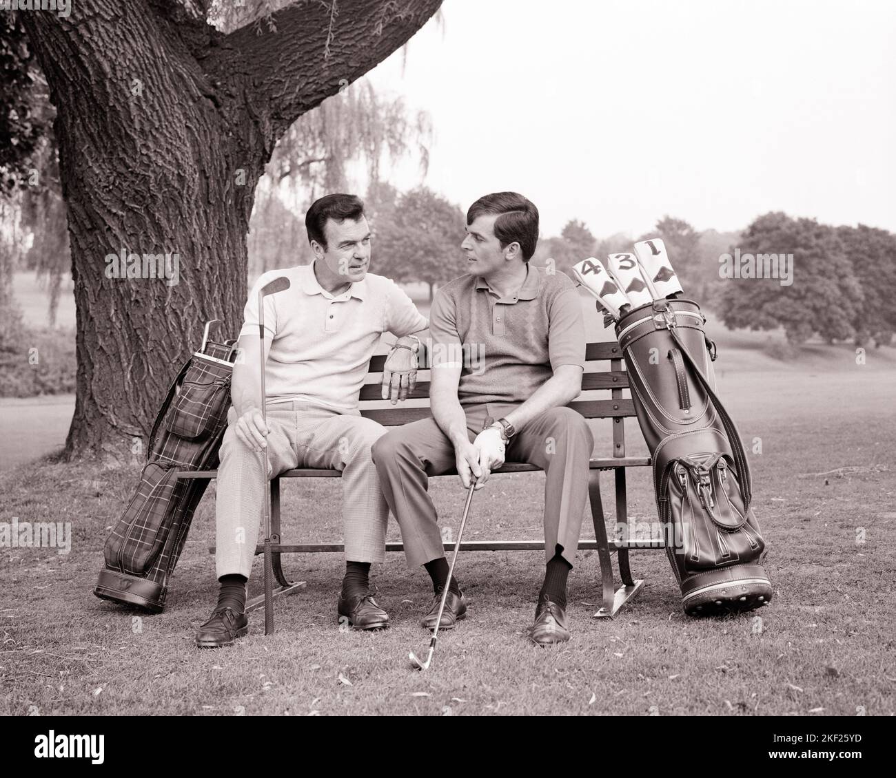 Two men sitting under tree hi-res stock photography and images - Alamy