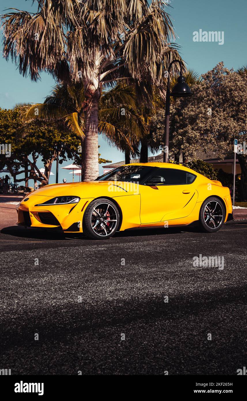 A yellow Toyota 2021 Supra with tinted windows, on the street road ...