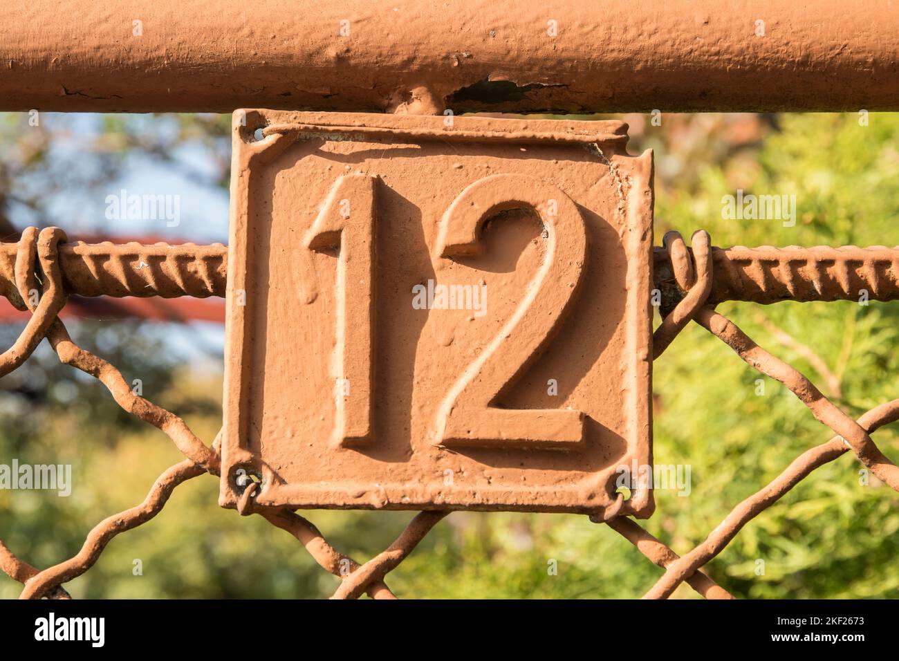 Old retro weathered cast iron plate number 12 closeup Stock Photo - Alamy