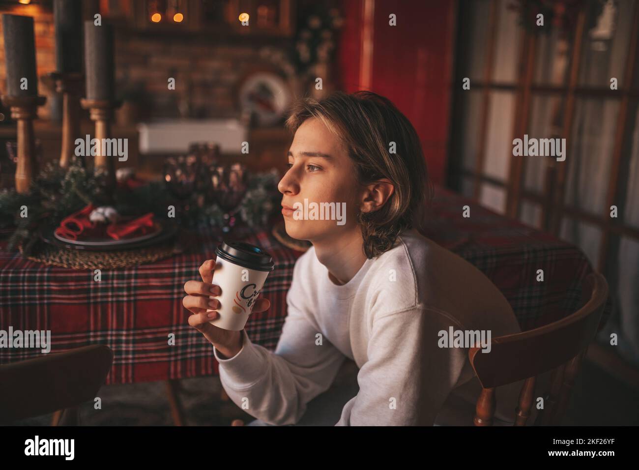 Young teen boy with long hair thoughtful look sad eyes negative mood ...