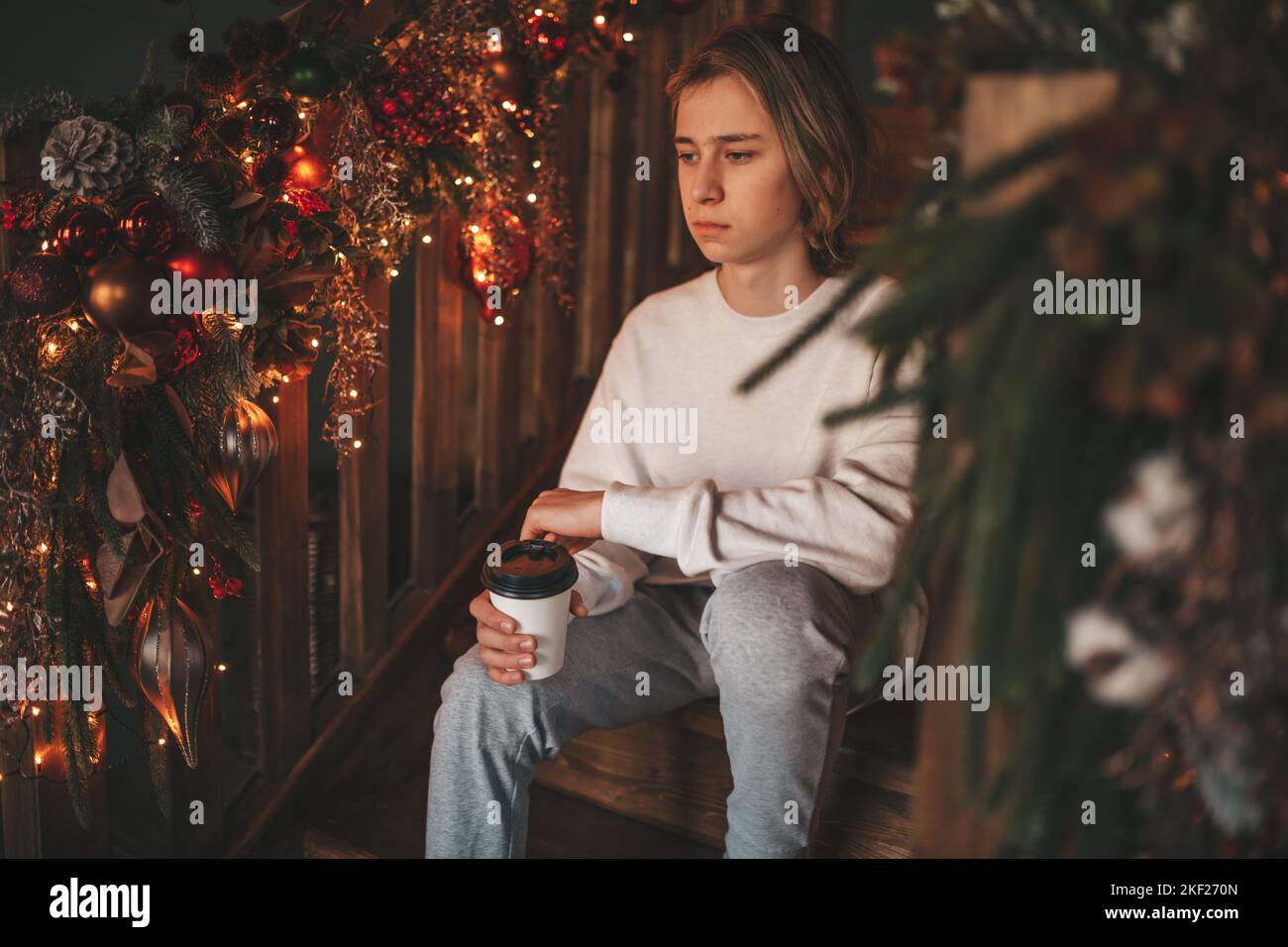 Young teen boy with long hair thoughtful look sad eyes negative mood ...