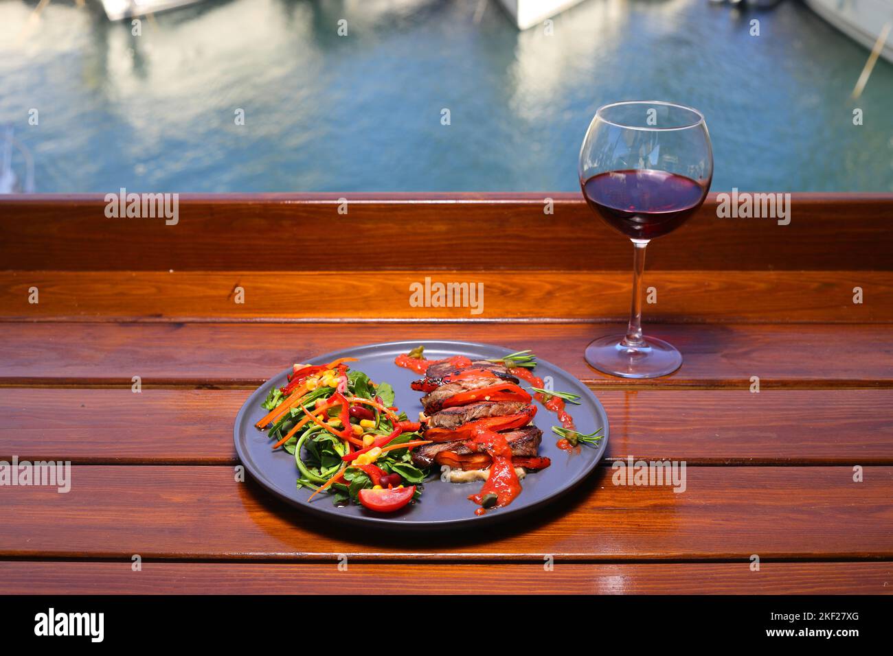 beef chop steak with salad , fried potatoes and sauce in dish. Food and ...