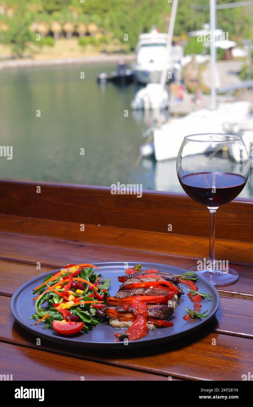 beef chop steak with salad , fried potatoes and sauce in dish. Food and ...