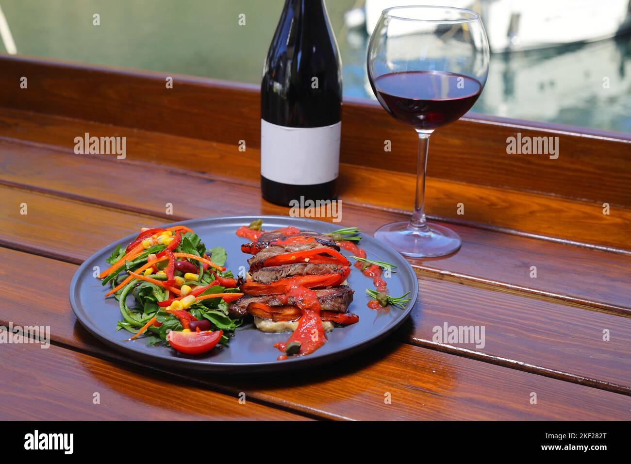 beef chop steak with salad , fried potatoes and sauce in dish. Food and ...