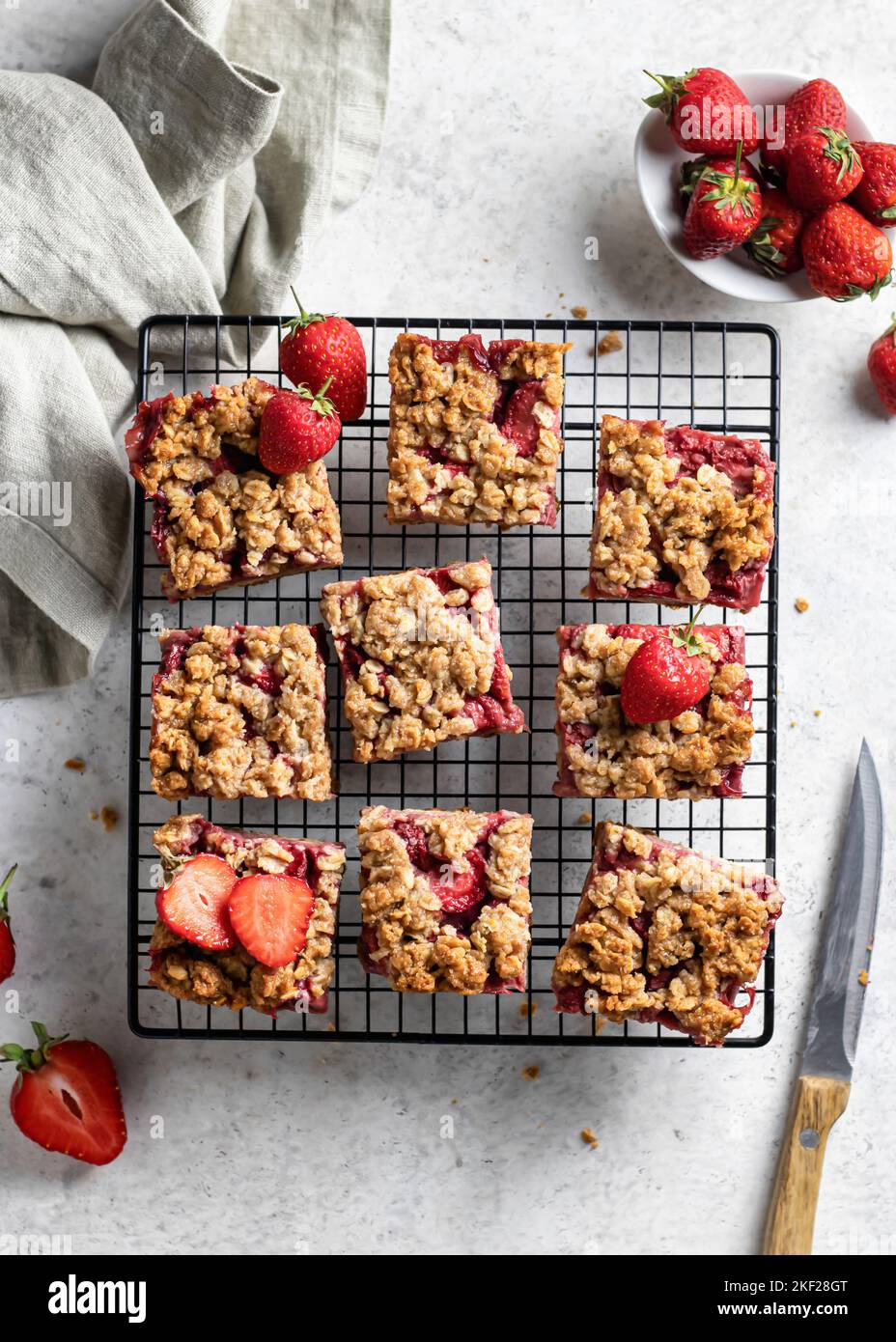 Homemade crumble strawberry bars with oatmeal on the baking cooling ...