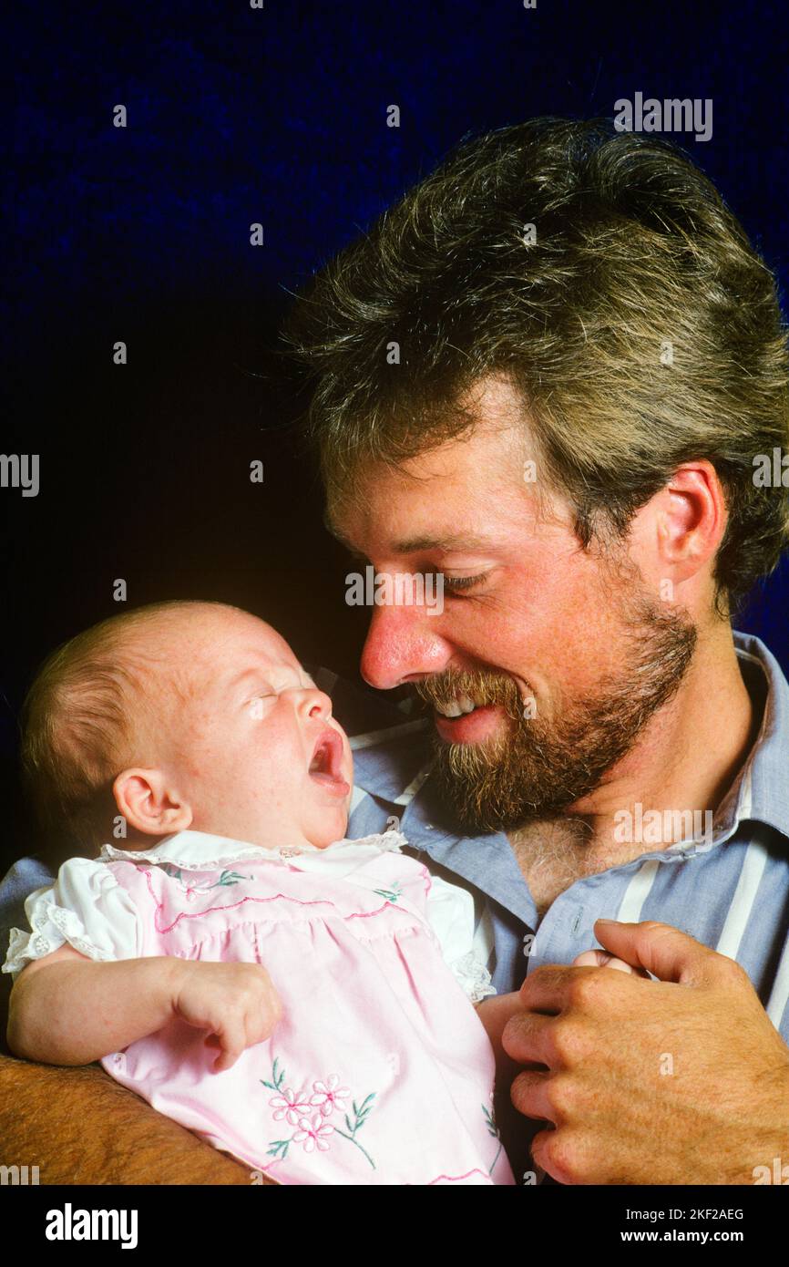 1990s BEARDED MAN FATHER SMILING HOLDING YAWNING INFANT BABY GIRL ...