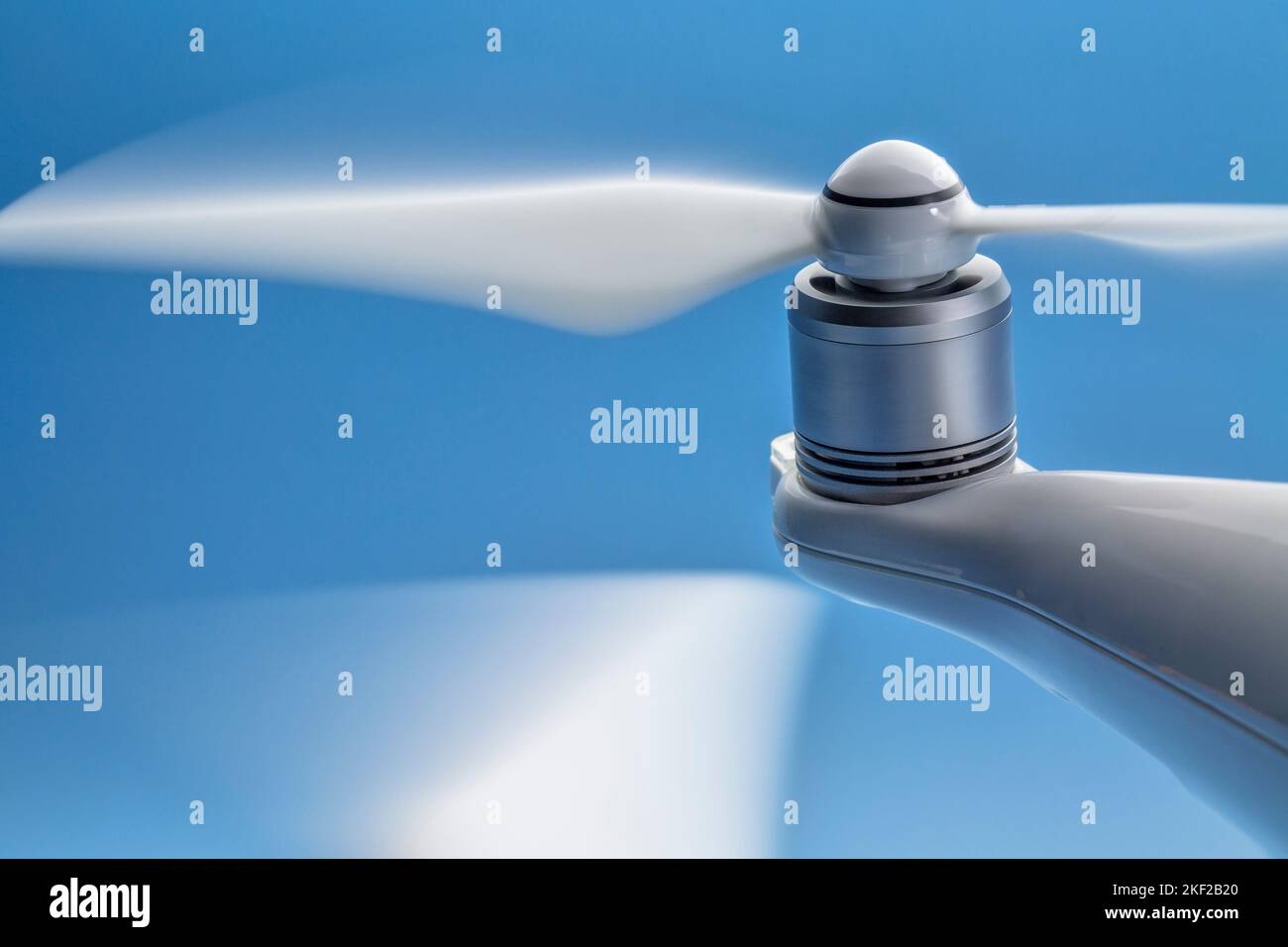 blurred spinning propeller of a quadcopter drone against blue sky Stock ...