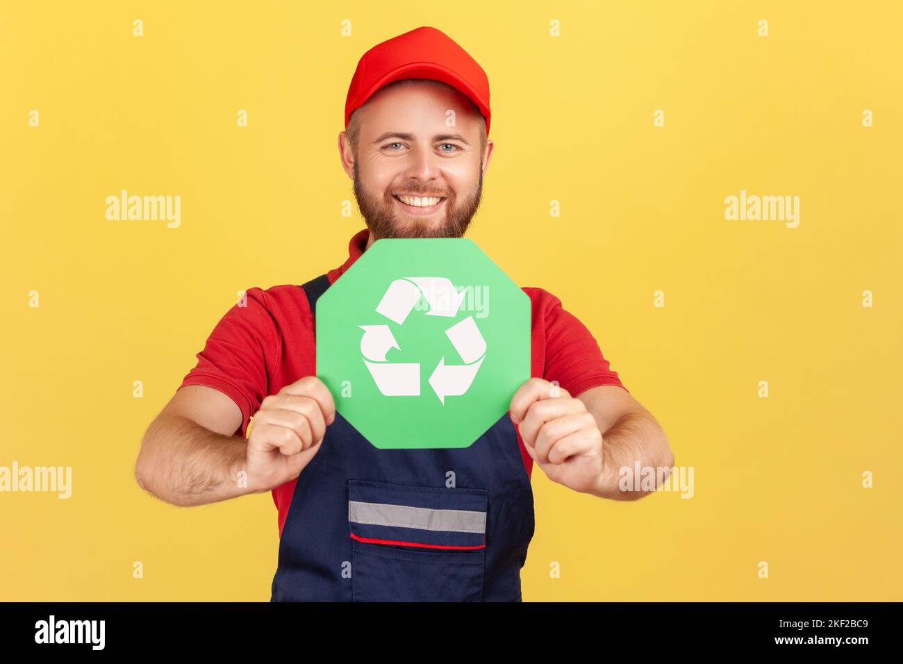 Portrait of smiling happy worker man standing and holding recycling ...