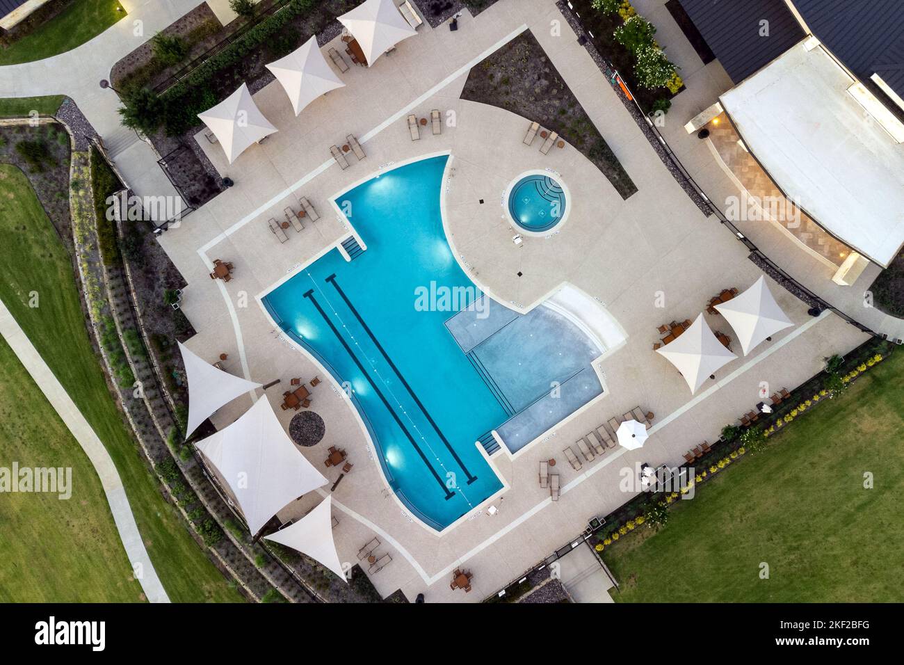Aerial shot of green lawn, swimming pool, lounge area near beautiful ...