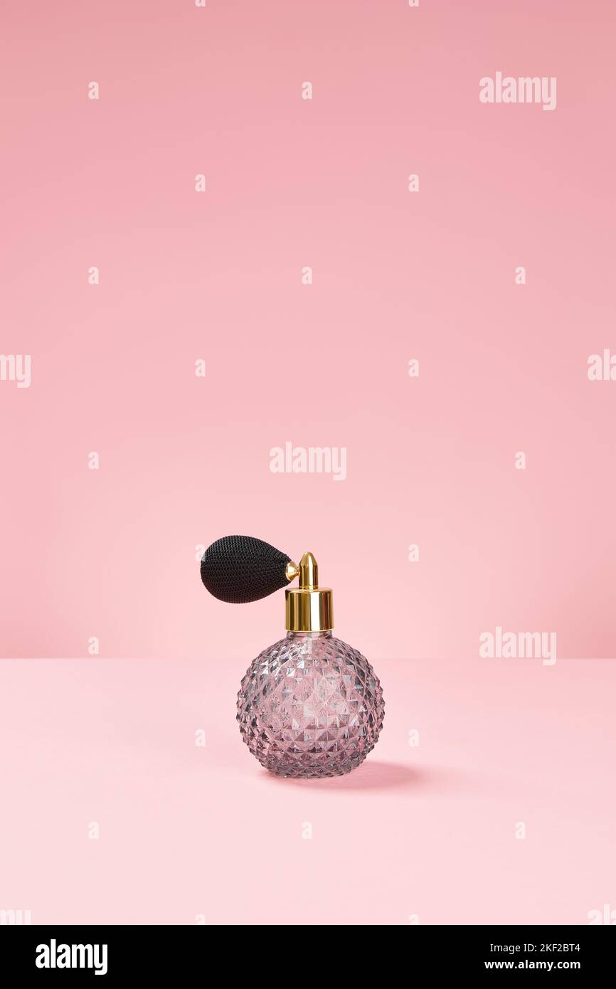 Retro bottle of essence perfume on pink background Stock Photo - Alamy