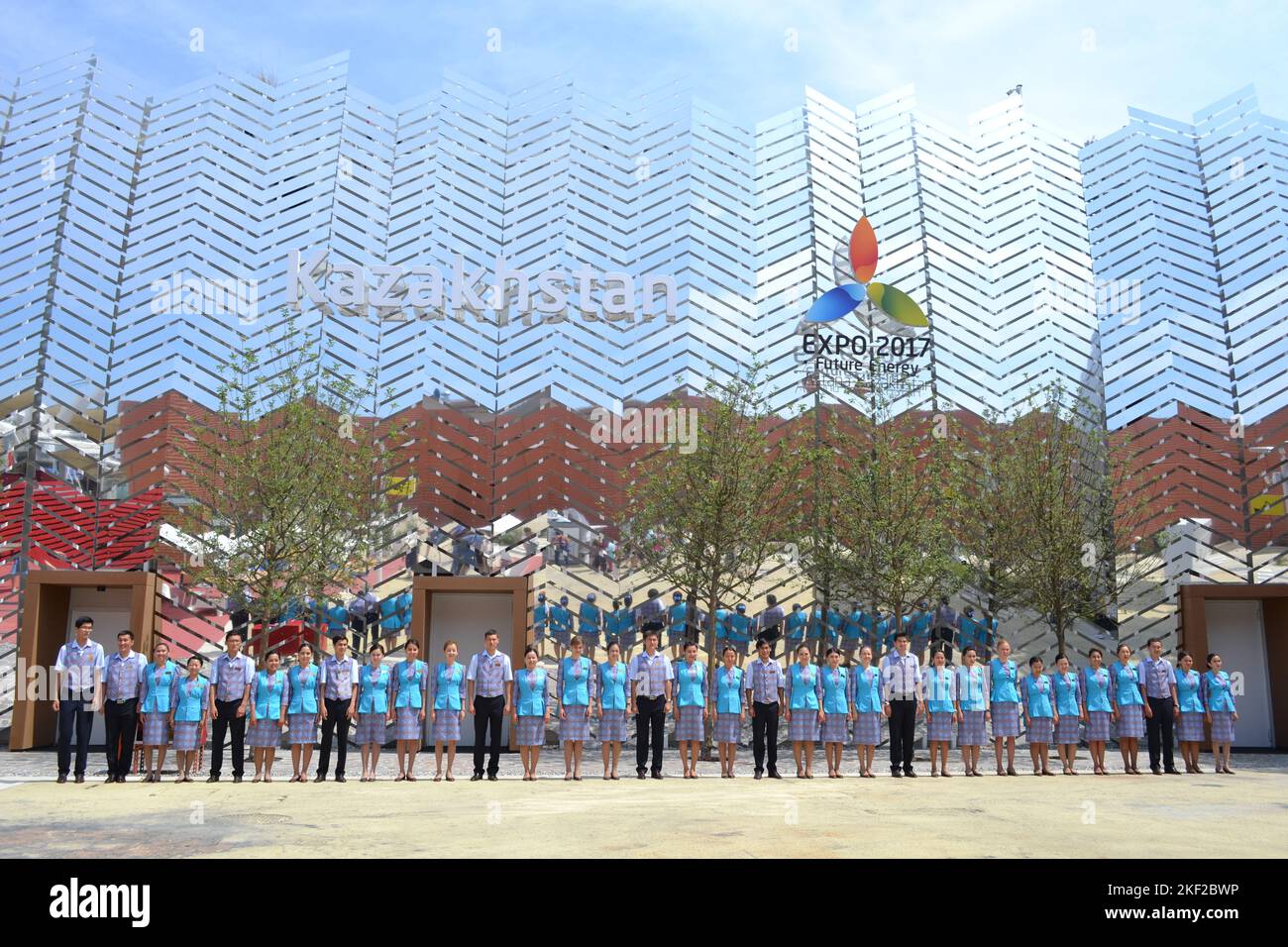 Kazakhstan pavilion staff team in uniform lined up in front of their ...