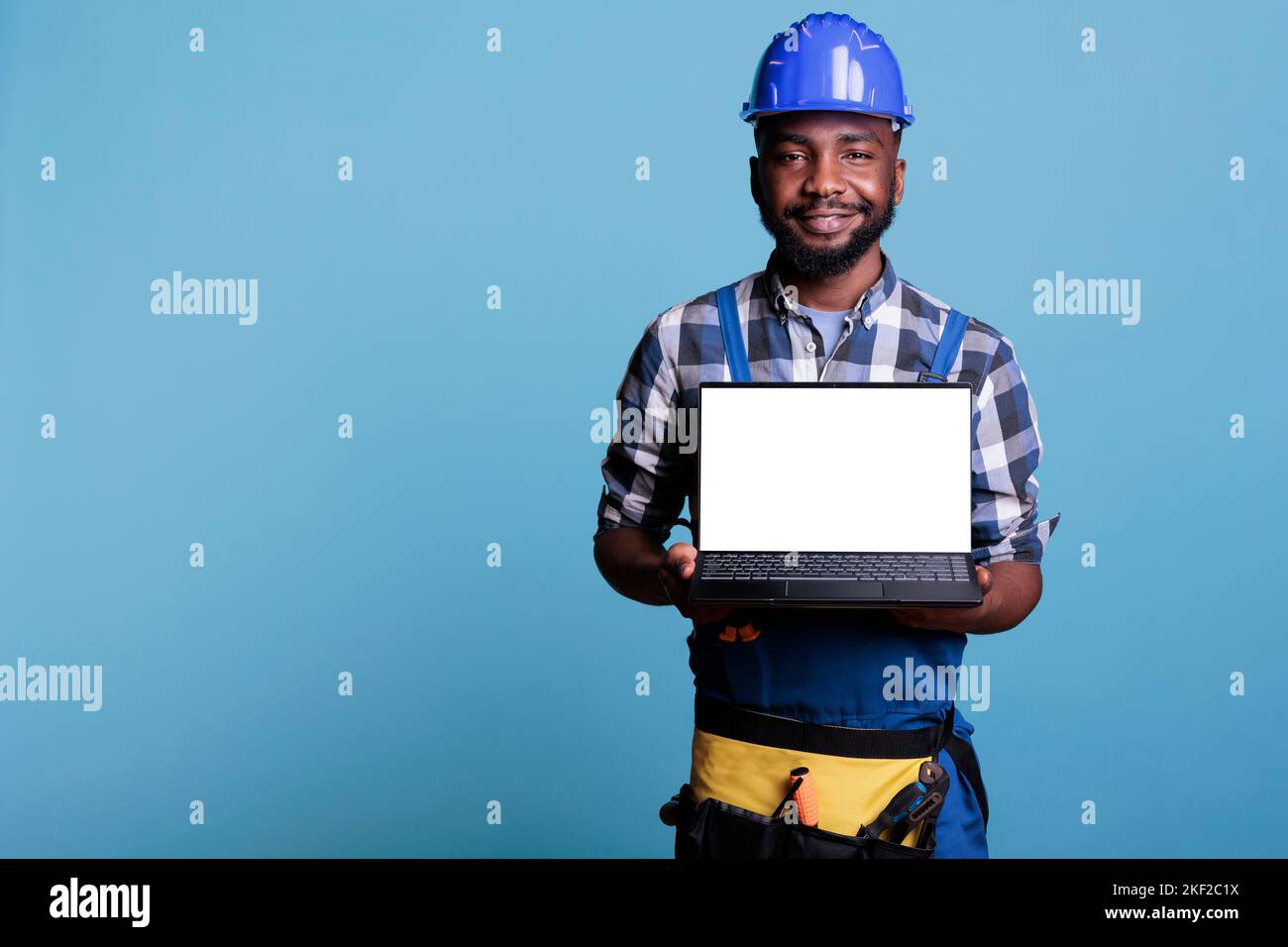 Optimistic african american man showing empty isolated laptop screen with copy space ...