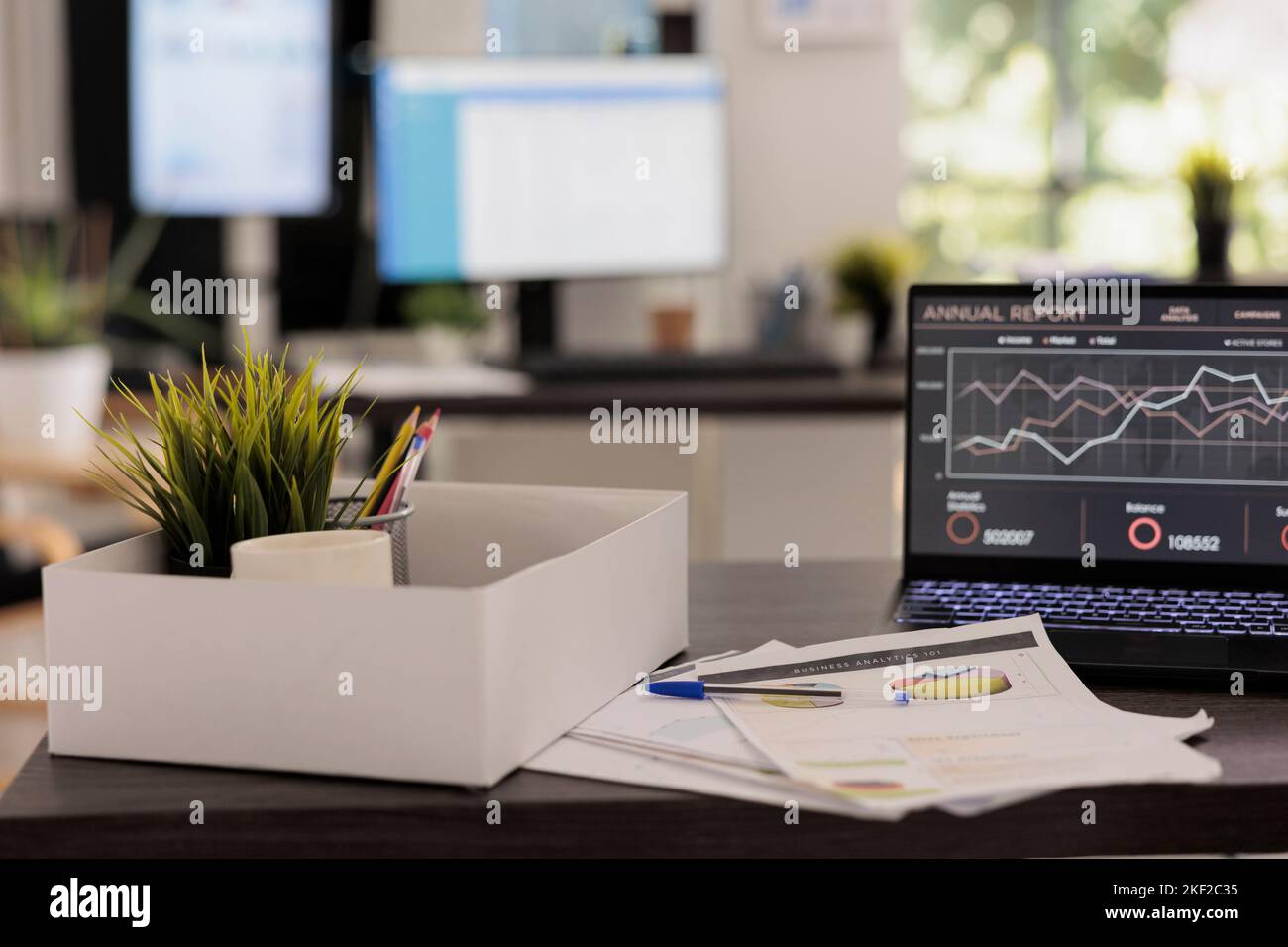 Sheets with printed statistical reports placed on desk in modern ...