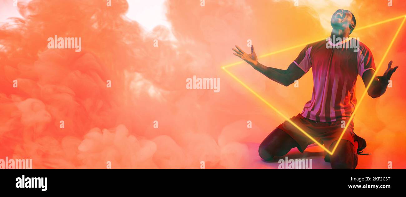 African american male player kneeling with illuminated triangle over ...