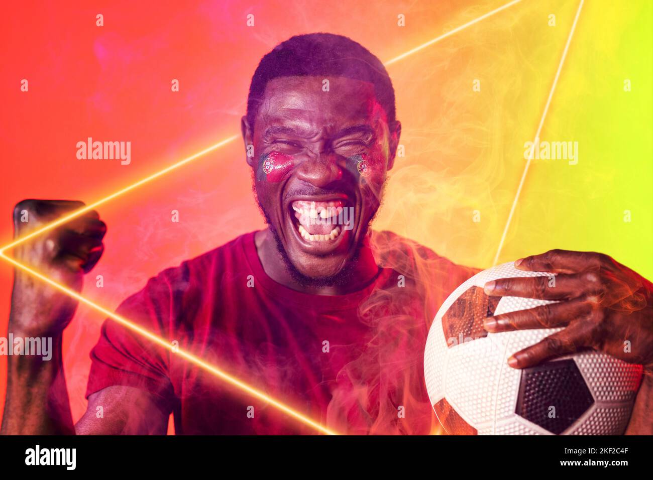 Cheerful african american soccer player with ball screaming by triangle ...