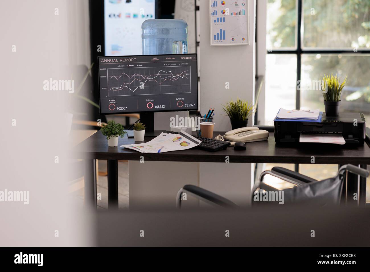 Interior of illuminated company workspace with desktop computer at the ...