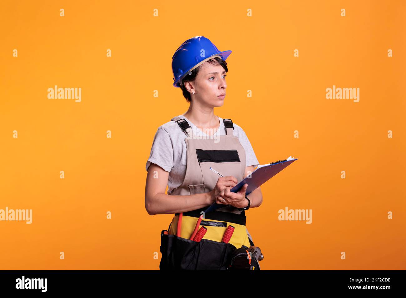 Construction worker taking notes and measurements to work on renovating ...
