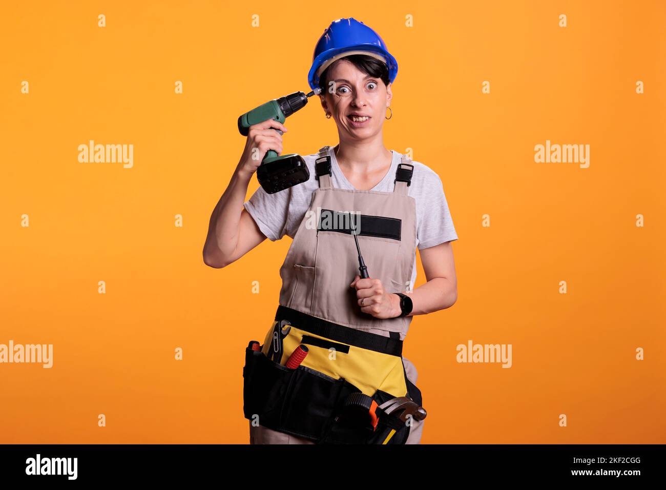 Woman repair employee holding power drill gun and having fun, acting ...