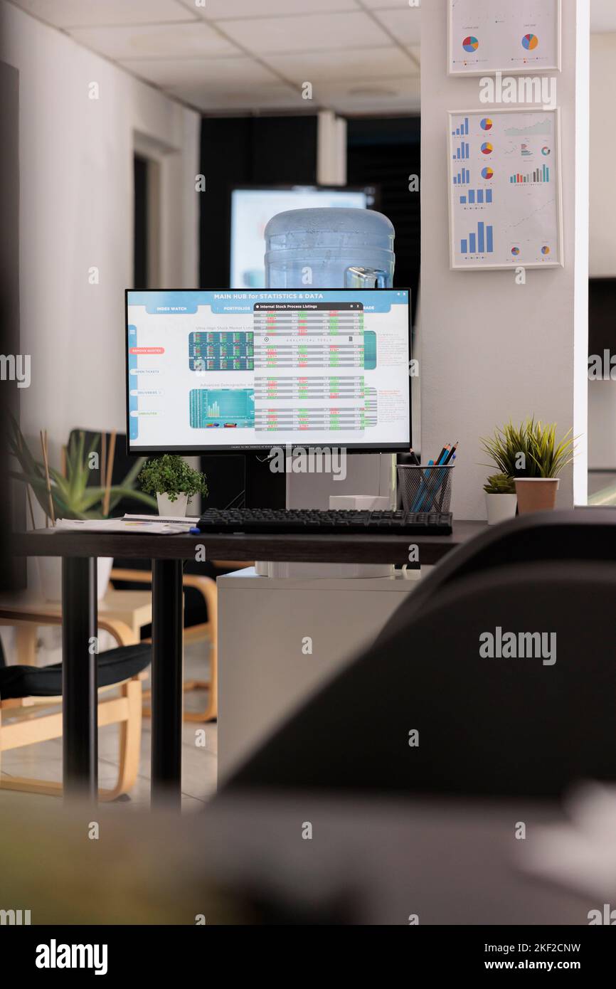 Office with no staff at end of work shift, monitor on desk with ...