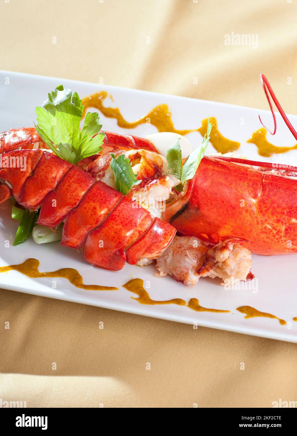 American lobster cooked with green peas, basil and capers Stock Photo ...