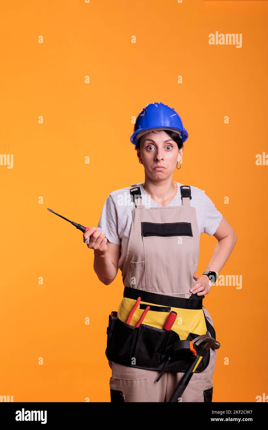 Inexperienced female builder doing renovation project and holding ...
