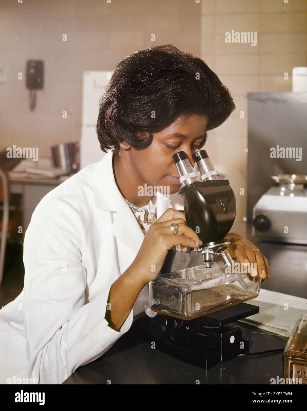 1960s AFRICAN-AMERICAN WOMAN RESEARCH TECHNICIAN AT MICROSCOPE SCANNING ...