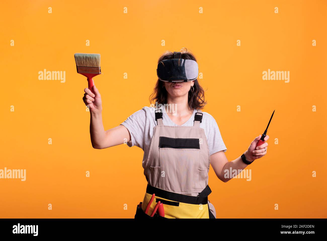 Young renovating expert using virtual reality headset to work on ...