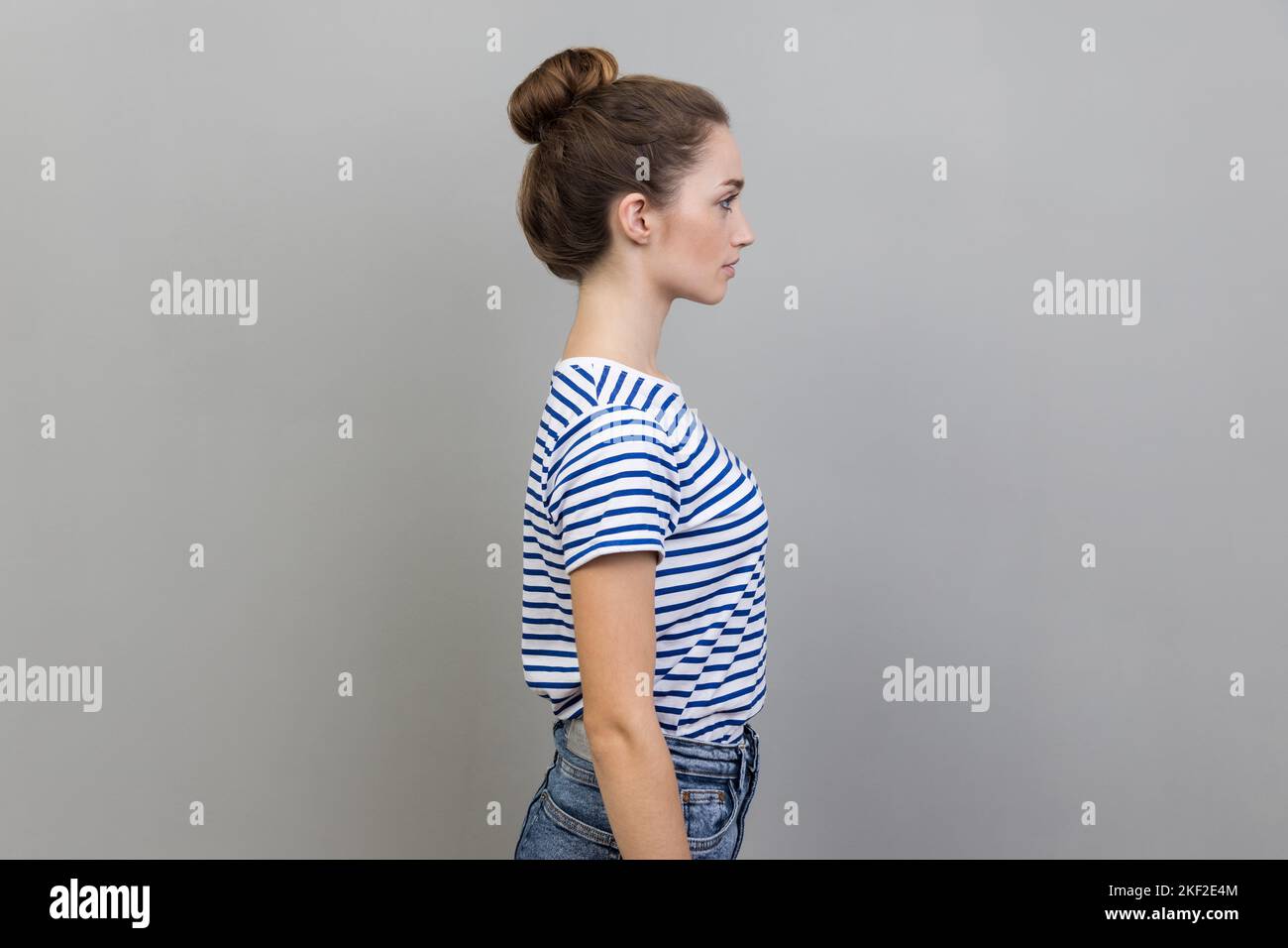 Side view portrait of beautiful serious bossy woman with bun hairstyle ...